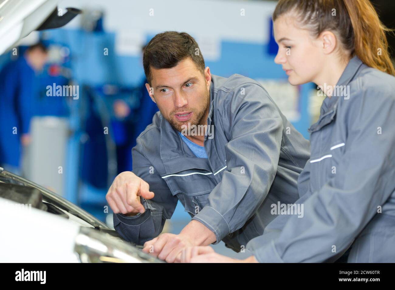 mechanics fixing the engine of a van Stock Photo - Alamy