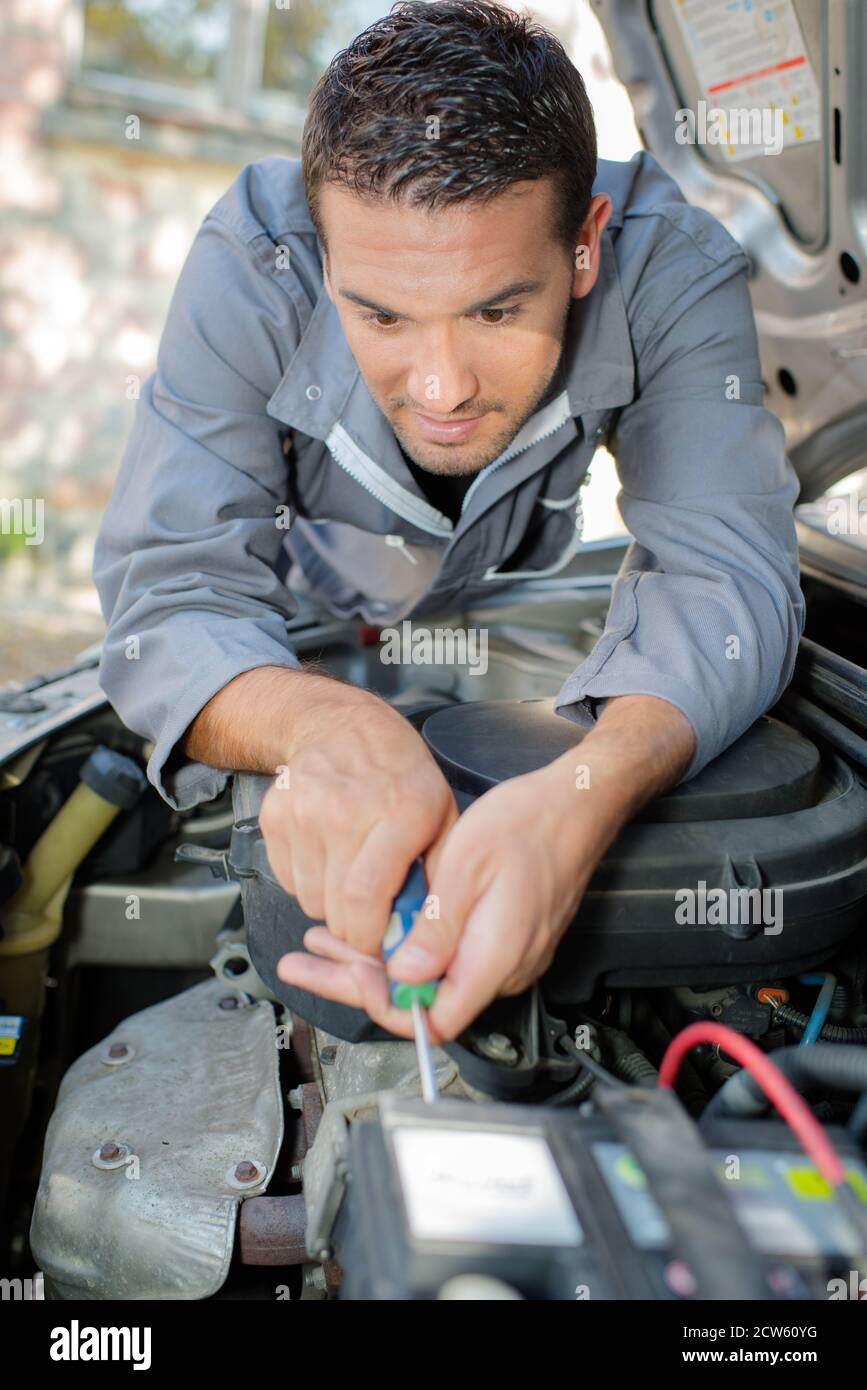 Man fixing a car engine Stock Photo - Alamy