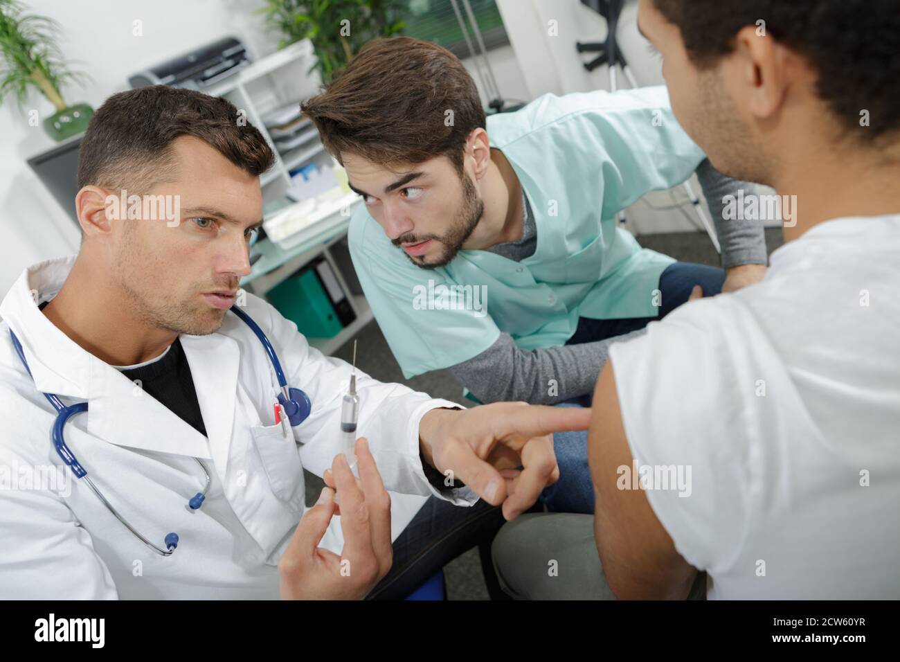 Nurse holding syringe team hi-res stock photography and images - Alamy