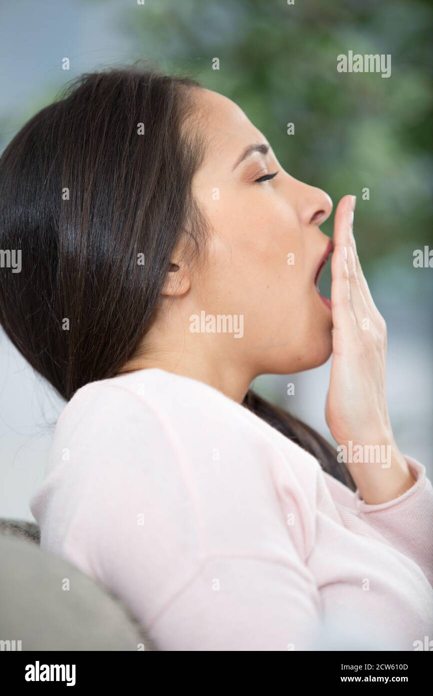 Tired woman yawning covering open hi-res stock photography and images ...