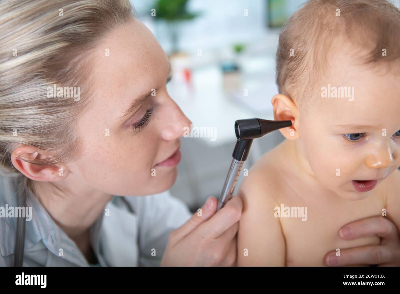 doctor checking baby ear with otoscope Stock Photo - Alamy