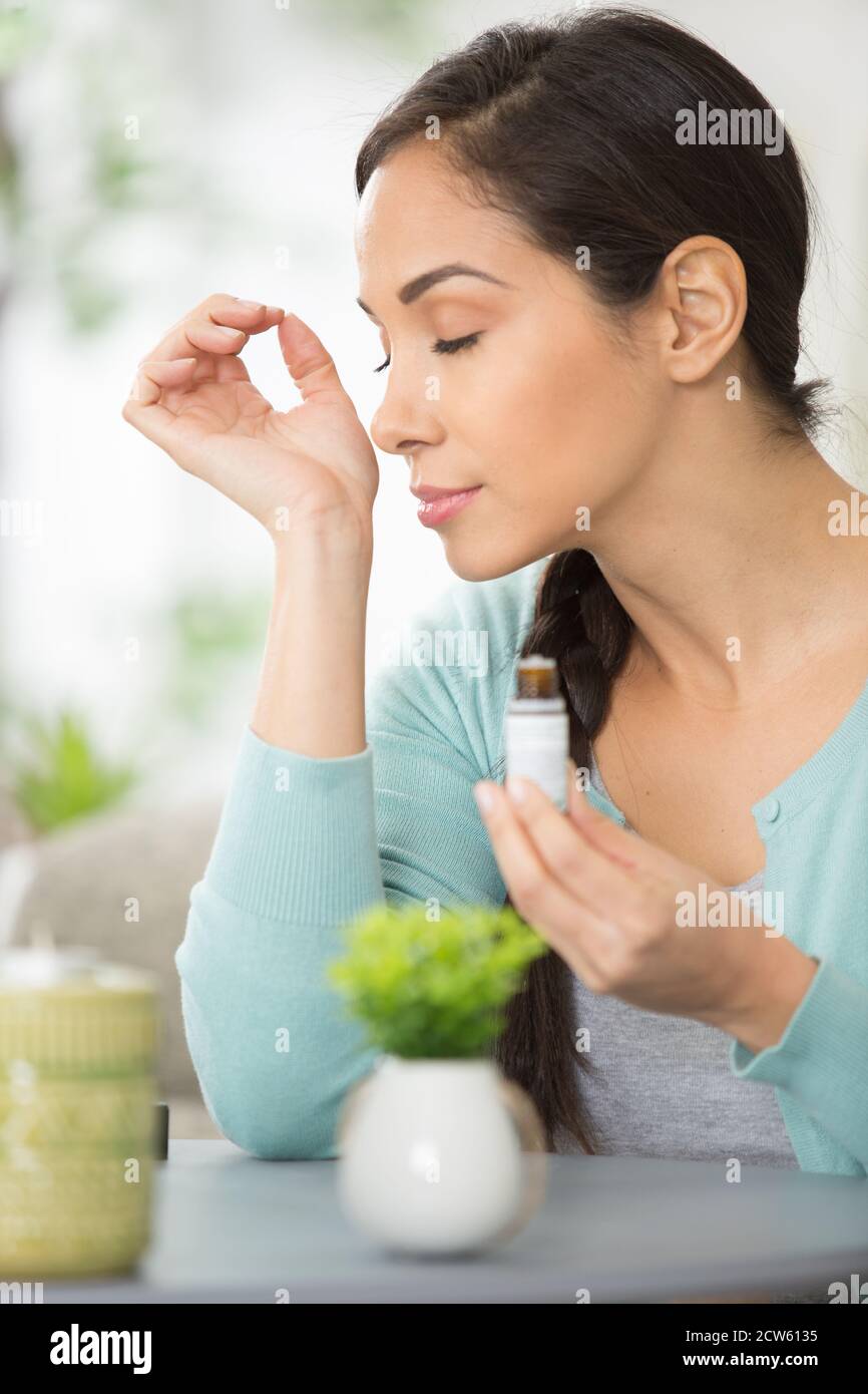 Woman using essential oil hi-res stock photography and images - Alamy