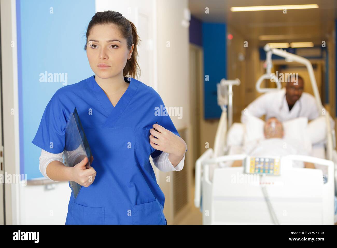 serious female nurse in hospital corridor Stock Photo - Alamy