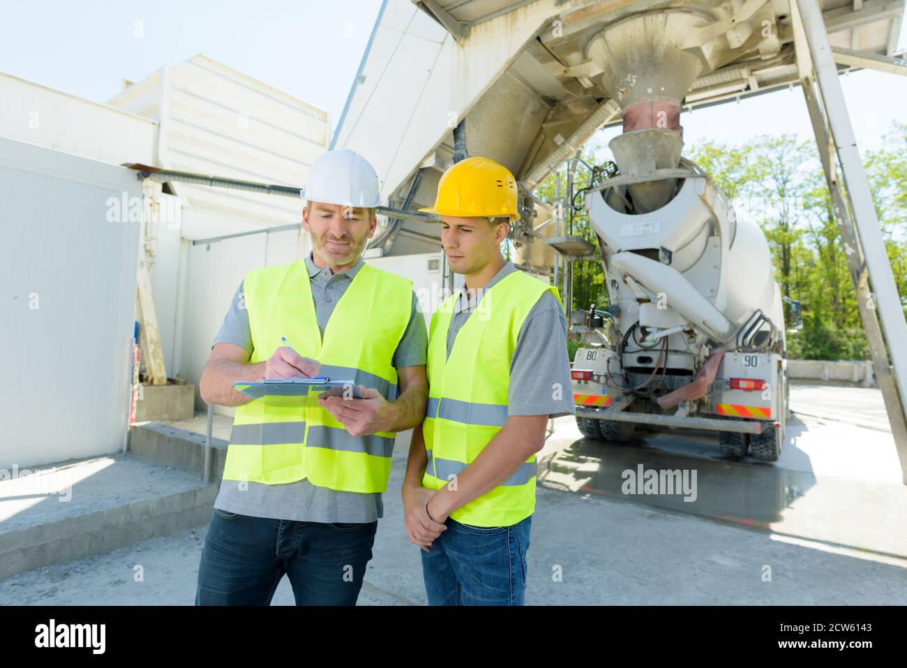 two civil engineer looking a blueprint in construction site Stock Photo ...