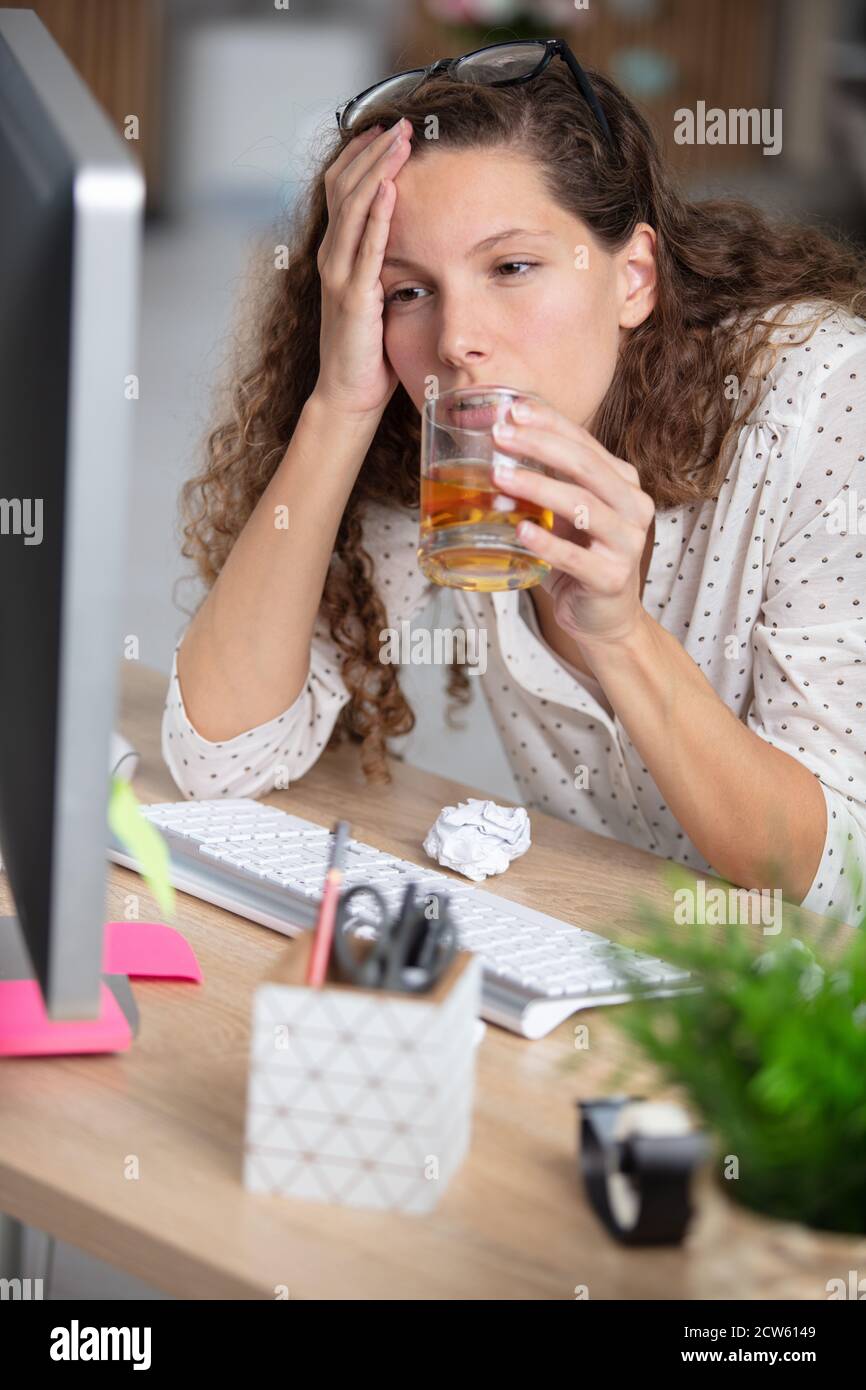 alcoholic business woman drinks at work sitting at a desk Stock Photo ...