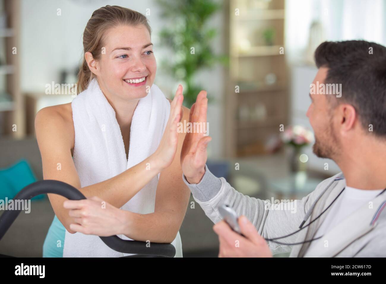 beautiful girl and her boyfriend greeting eachother with a high-five ...
