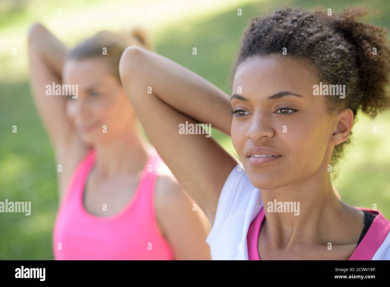 two pretty women stretching in a park before workout session Stock ...