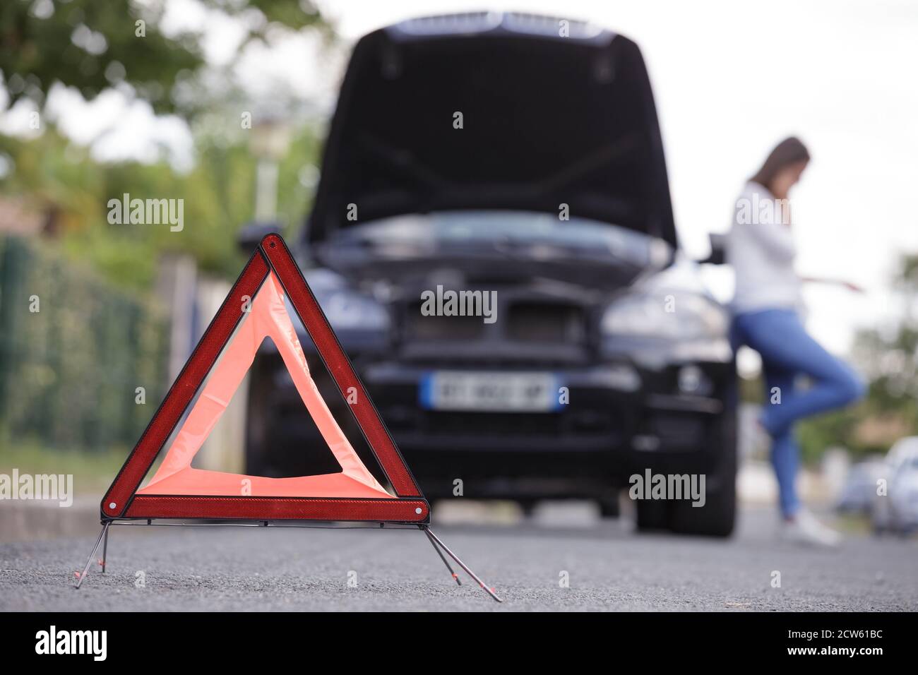 broken car concept breakdown triangle on road Stock Photo - Alamy