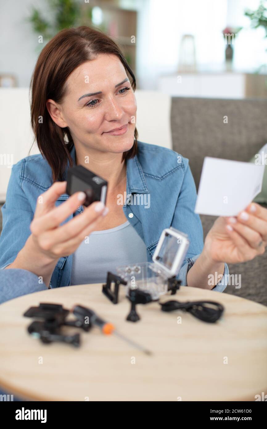 female tech repairing gopro camera Stock Photo - Alamy