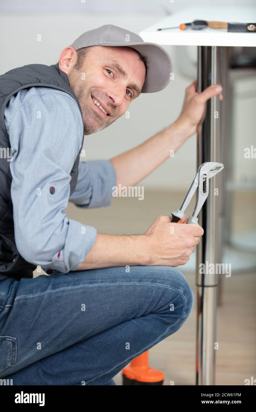man repairing furniture at home Stock Photo - Alamy