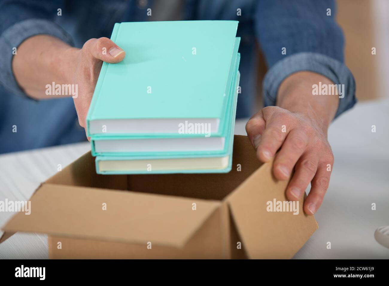 Girl packing books hi-res stock photography and images - Alamy