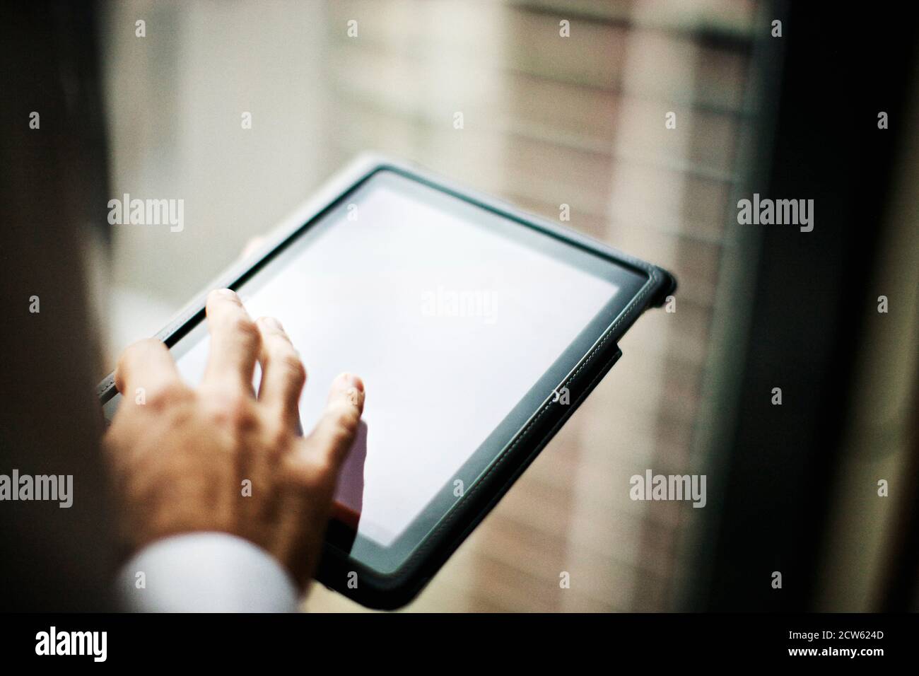 hand on tablet in business meeting Stock Photo - Alamy