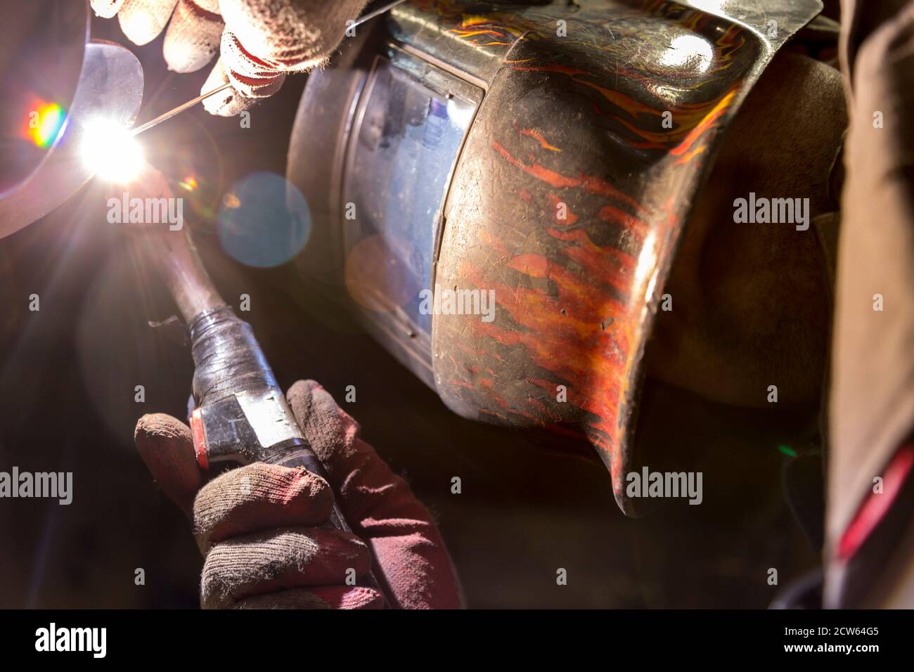 Welder solders copper car radiator with gas torch Stock Photo - Alamy