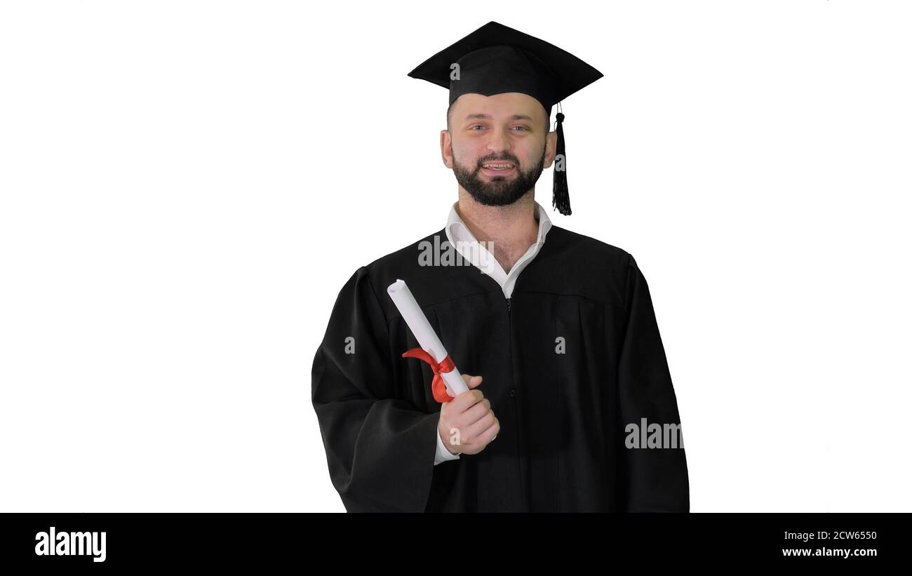Happy young man in graduation hat holding diploma and talking on Stock ...