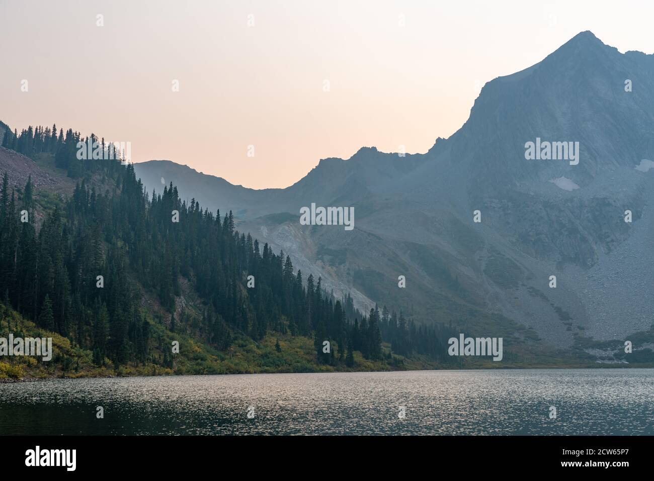 View of Snowmass Lake and Snowmass Peak on a hazy summer evening near ...