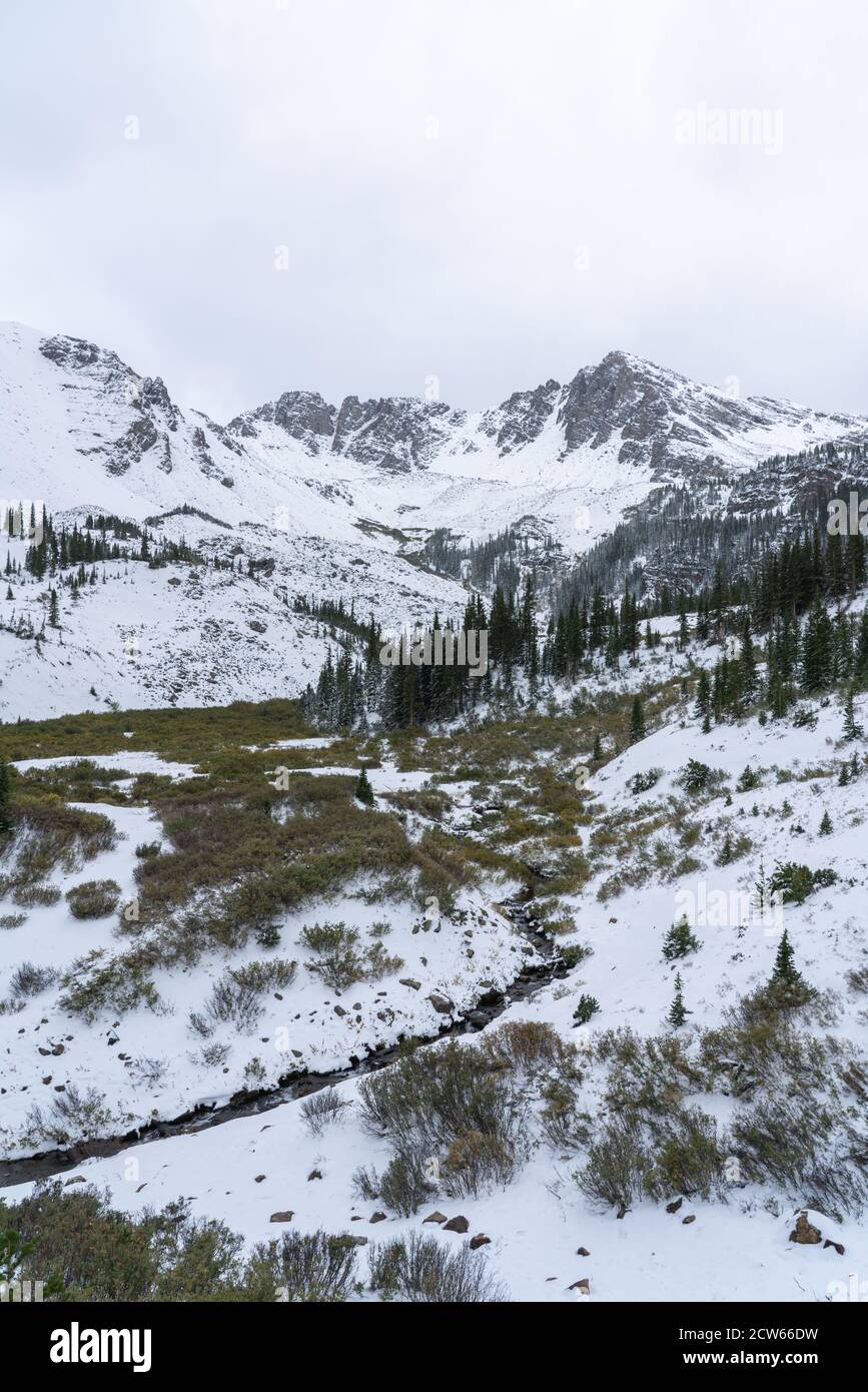 Summer snow covering the ground during a hike to Cathedral Lake near ...