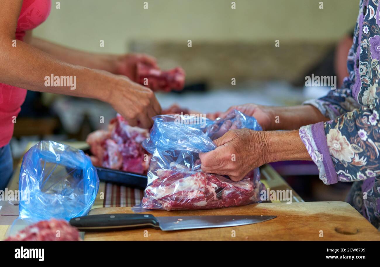 Buying beef from the local butcher, anonymous hands handling the meat ...