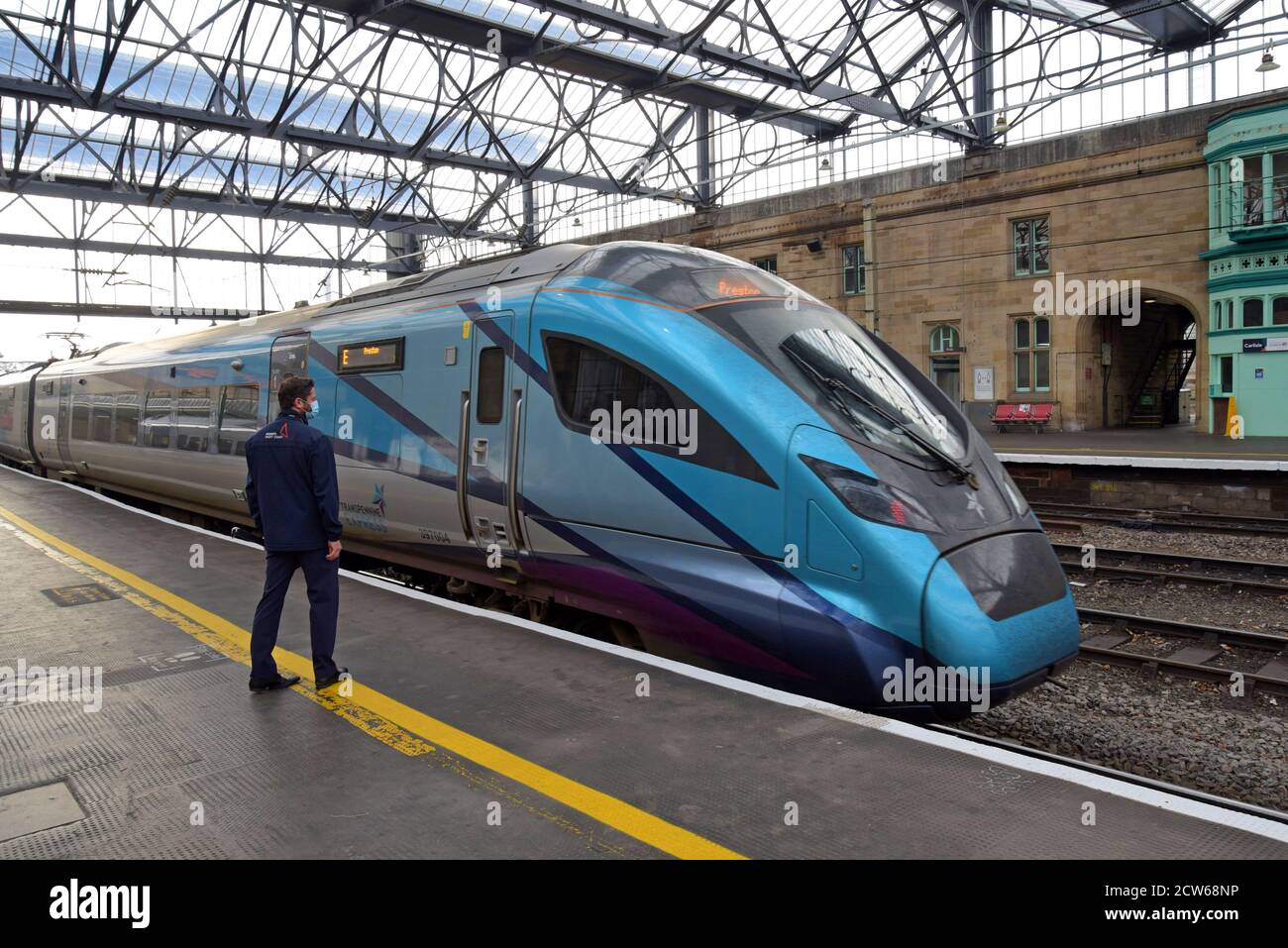 A railway train despatcher wearing a face mask watches a Trans Pennie ...