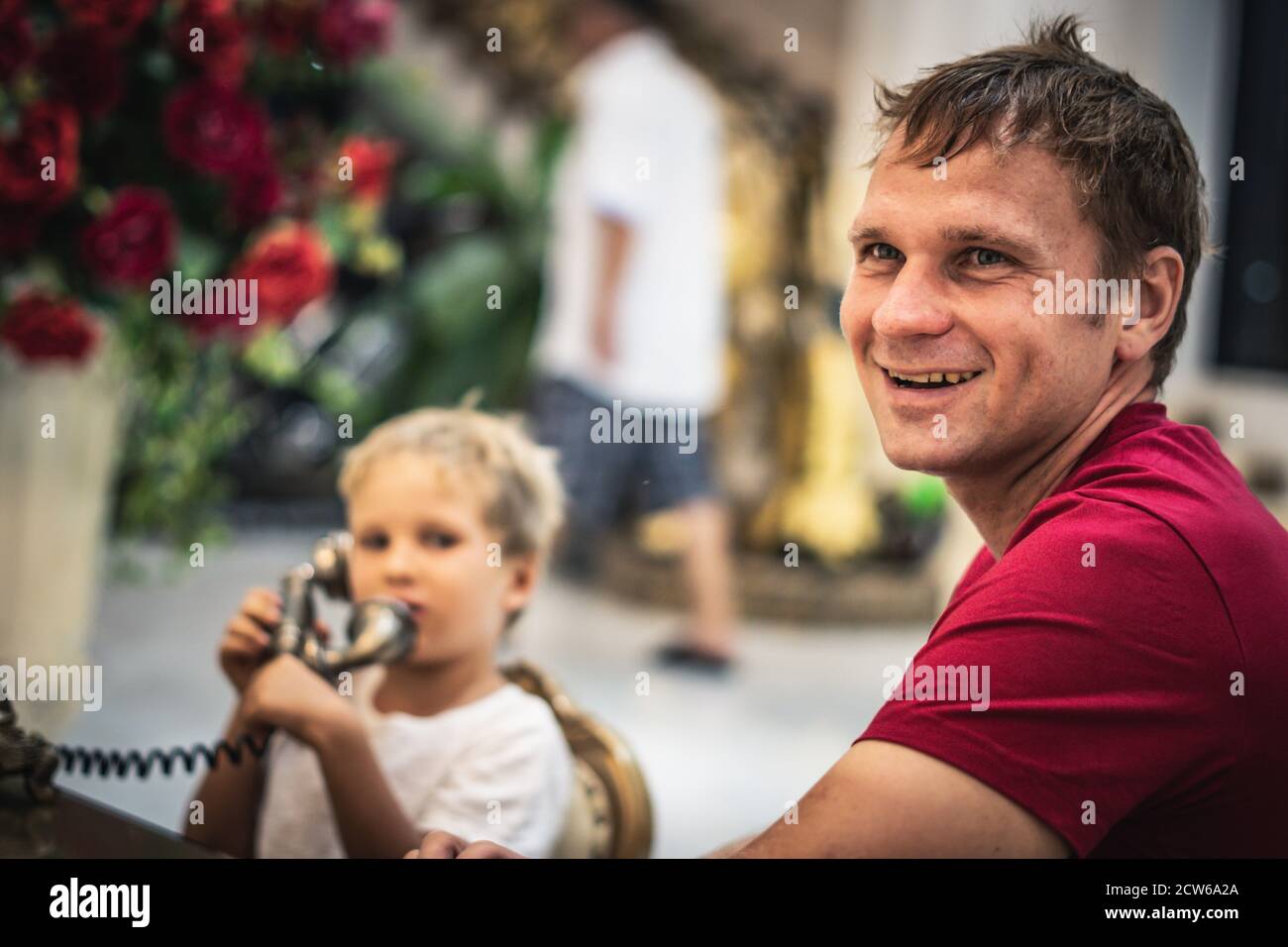 Boy play with antique vintage rotary old landline hang up phone ...
