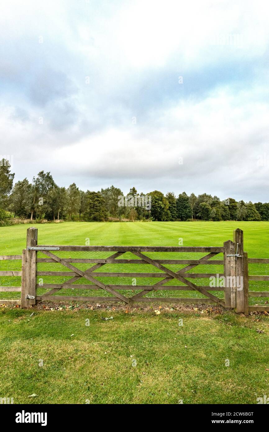 Wooden Five Bar farmers field gate with plain lawn behind Stock Photo ...
