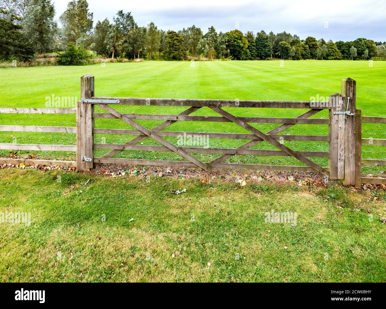 Wooden Five Bar farmers field gate with plain lawn behind Stock Photo ...