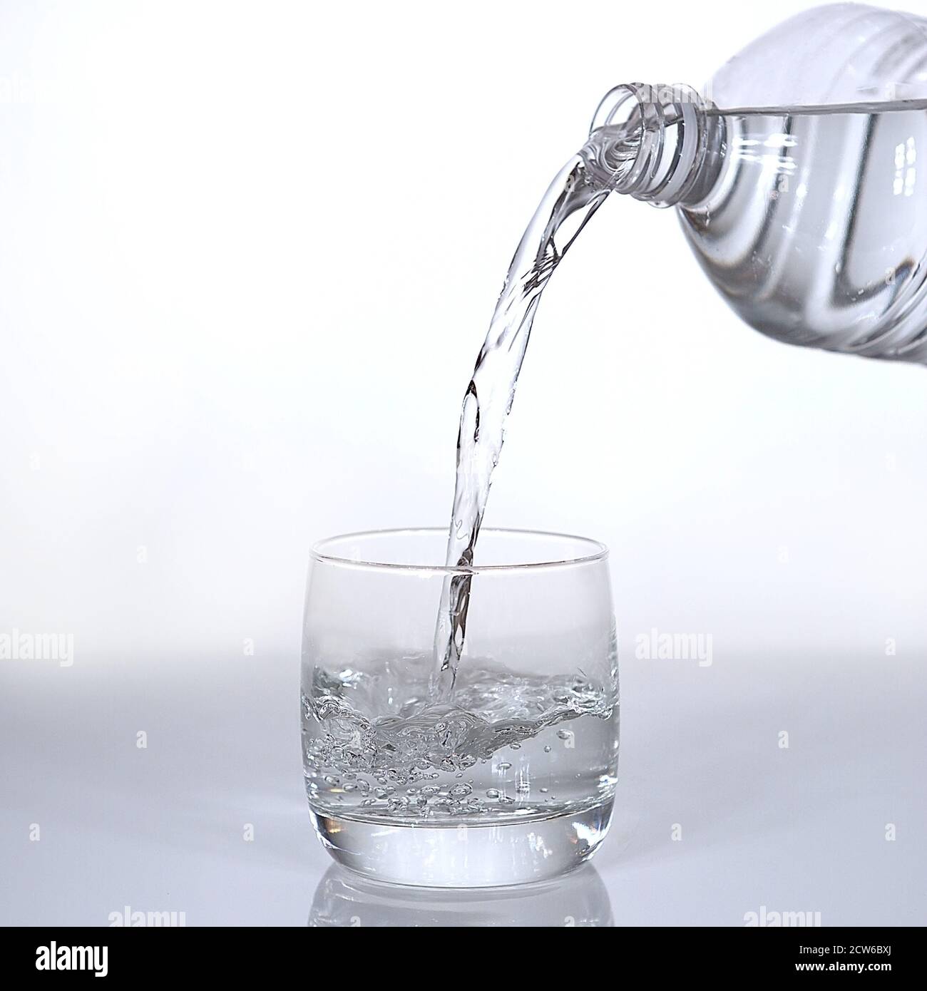 Water being poured into Glass against White Background Stock Photo - Alamy Water being poured into Glass against White Background Stock Photo - Alamy