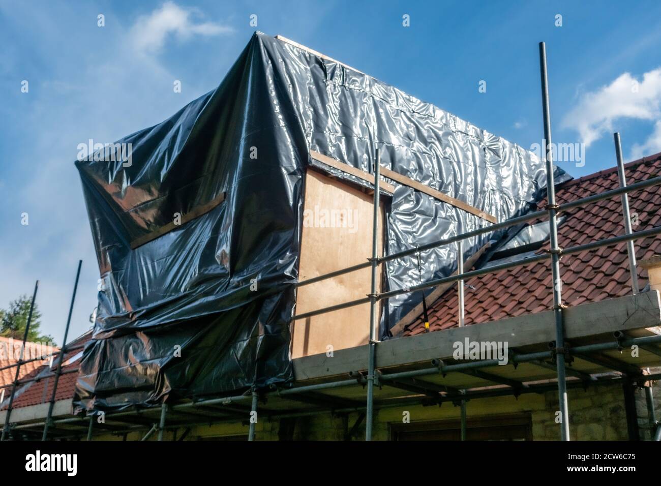 builders temporary roof coverage on house Stock Photo - Alamy