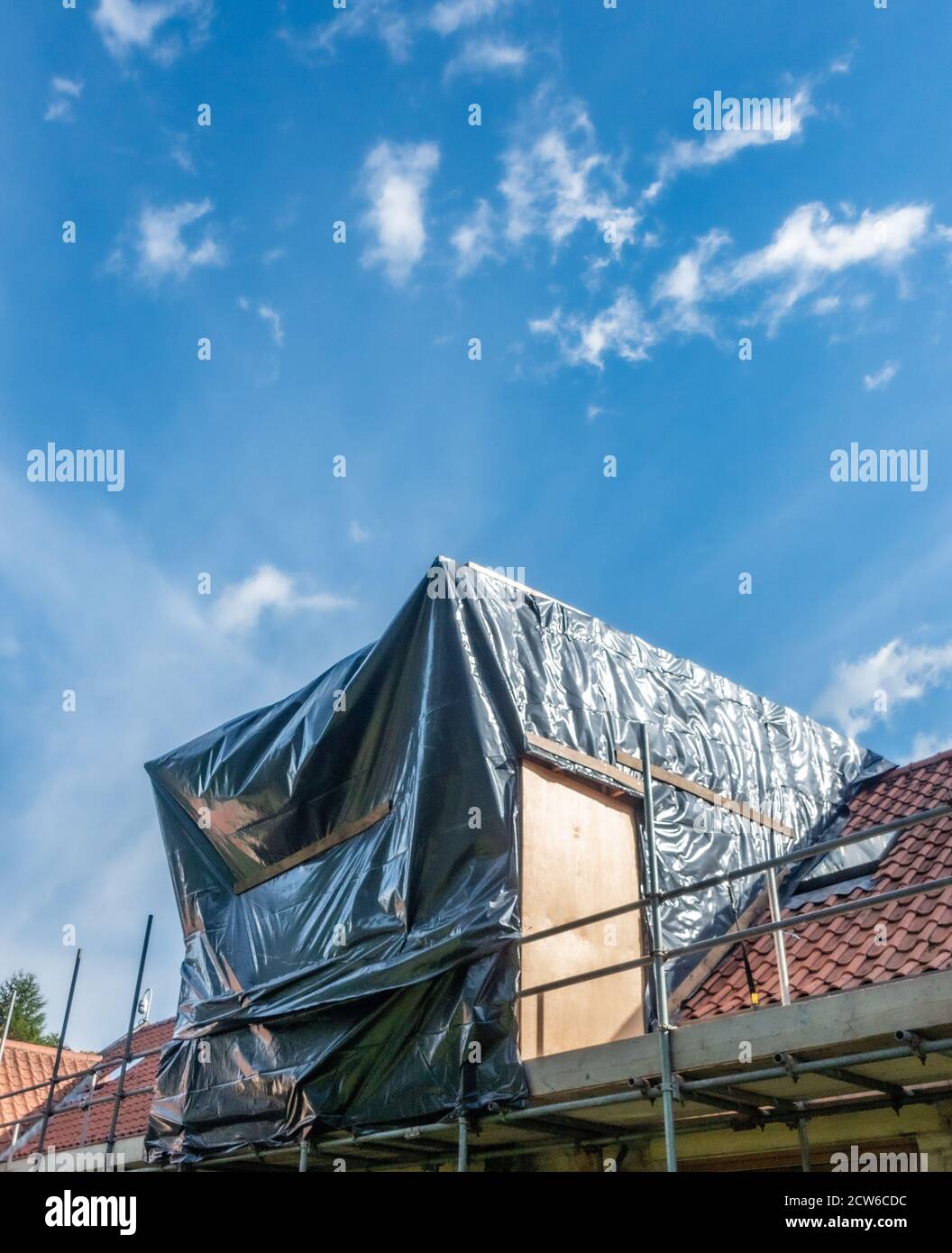 builders temporary roof coverage on house Stock Photo - Alamy
