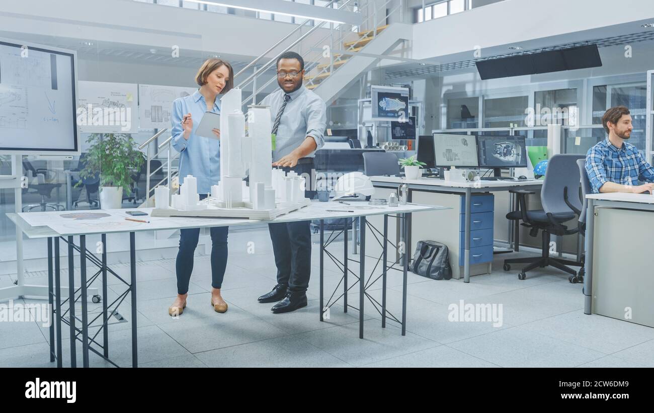 In Architectural Bureau: Architect and Engineer Talking, Working on a ...