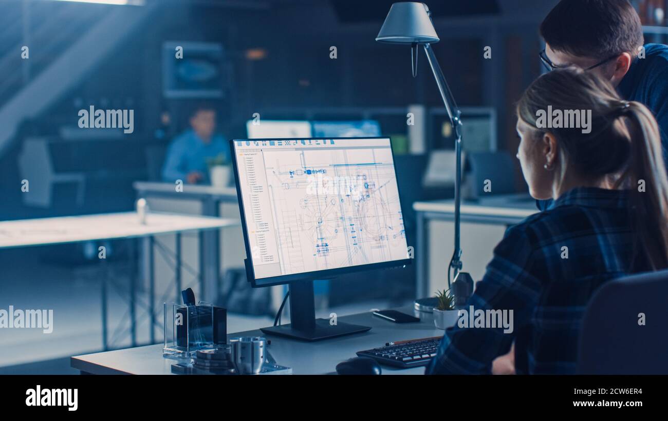 Engineer Working on Desktop Computer, Screen Showing CAD Software with ...
