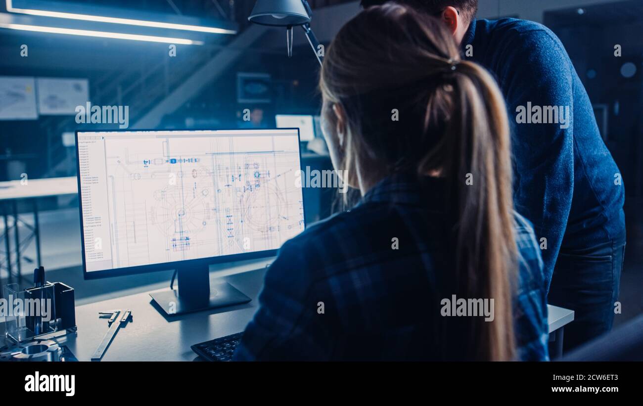 Engineer Working on Desktop Computer, Screen Showing CAD Software with ...