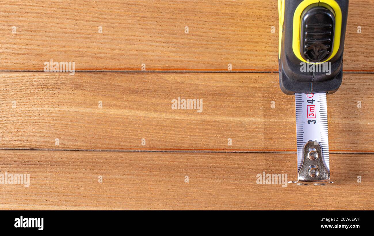 Measuring tape with numbers centimeters on a wood brown background ...