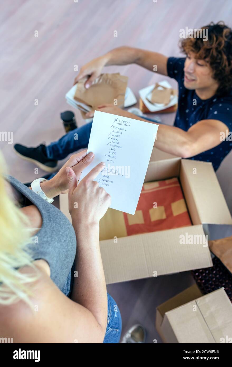Couple unpacking moving boxes Stock Photo - Alamy