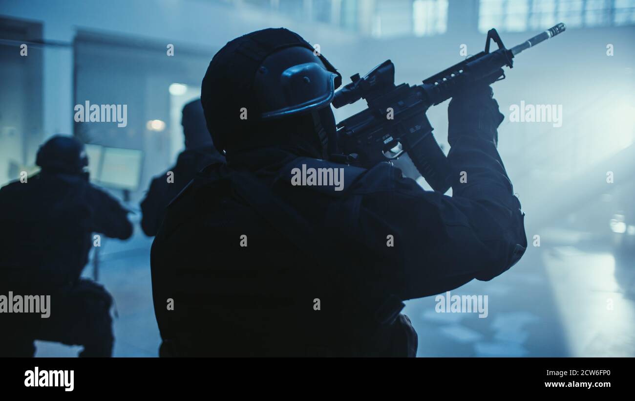 Portrait of Masked Armed SWAT Police Officer Storming Dark Seized ...