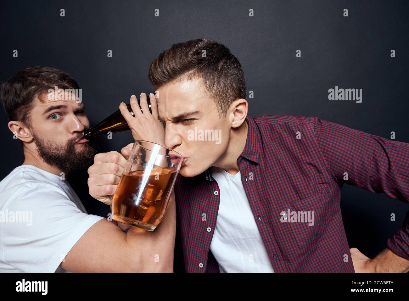 Two drunk friends drinking beer rest fun dark background Stock Photo ...