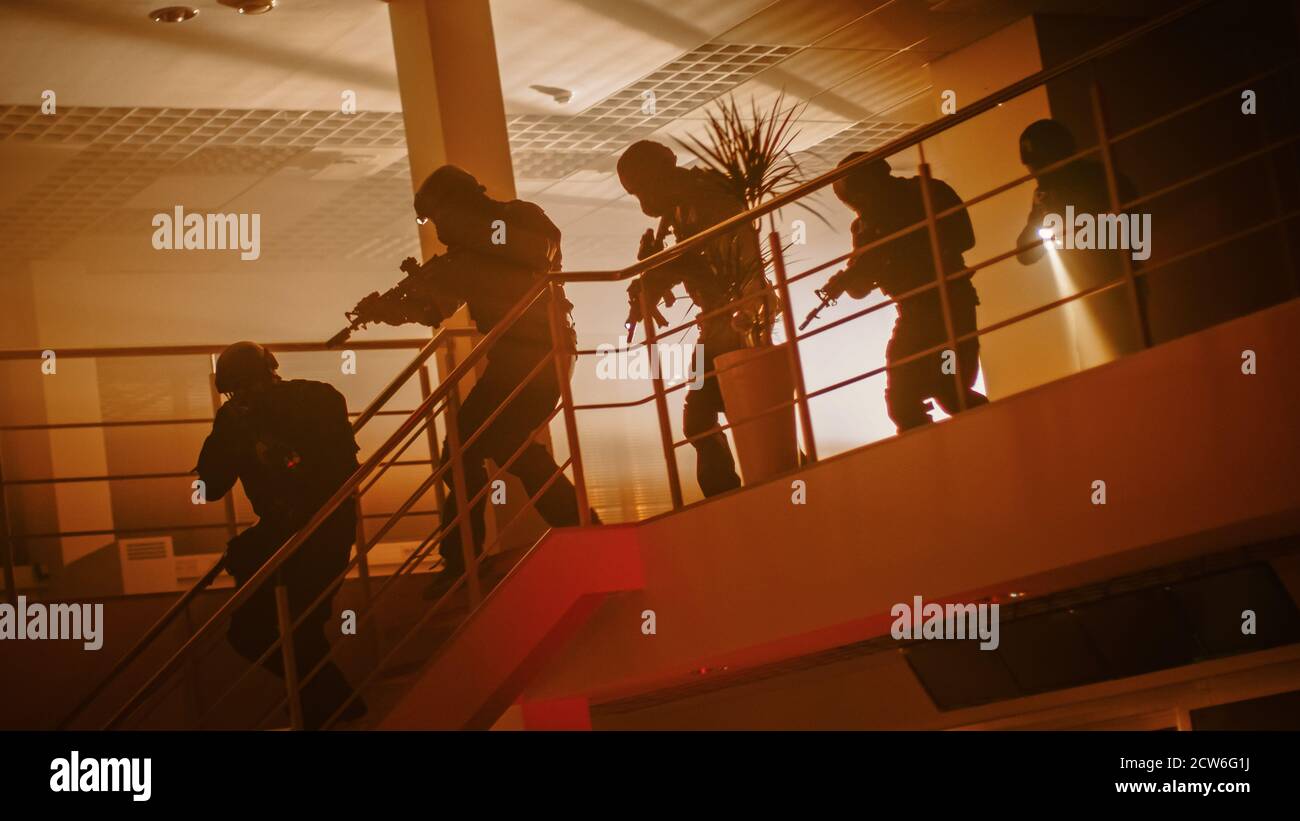 Masked Squad of Armed SWAT Police Officers Run Down the Stairs from a ...