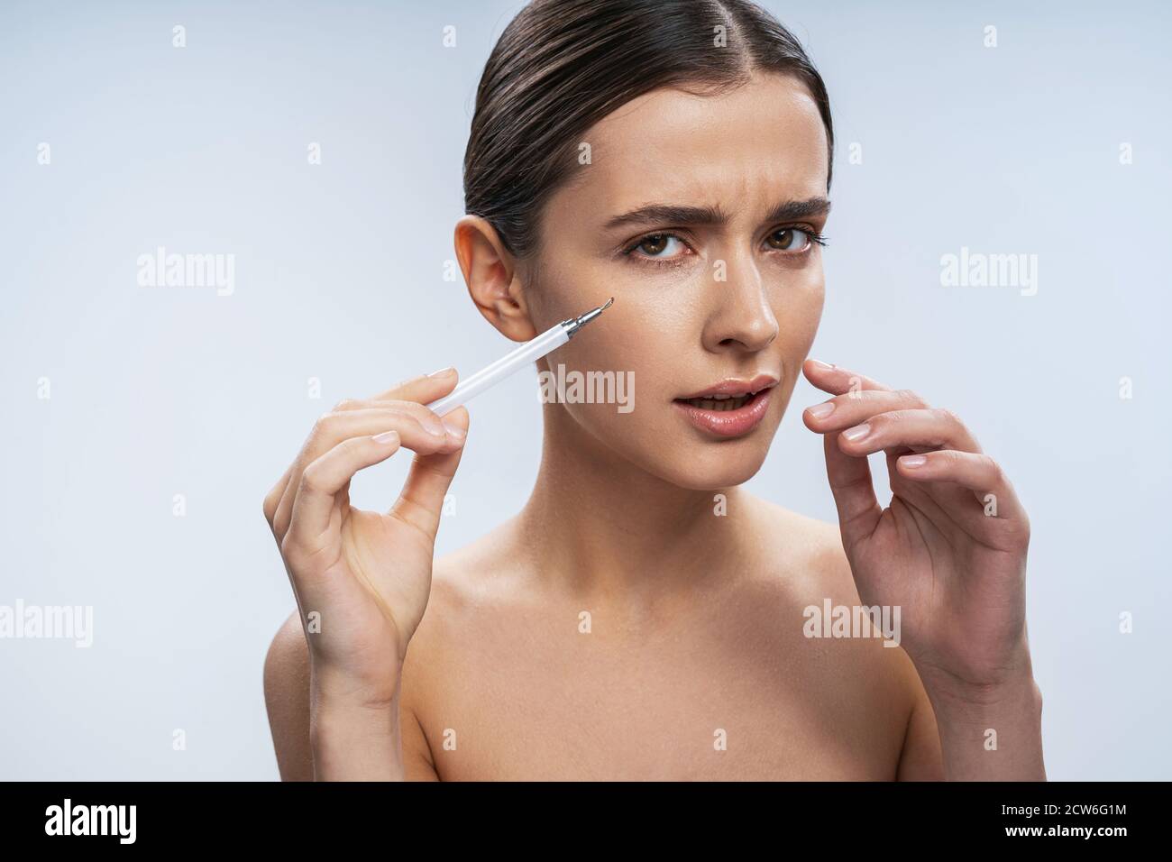 Woman receiving injection into forehead hi-res stock photography and ...
