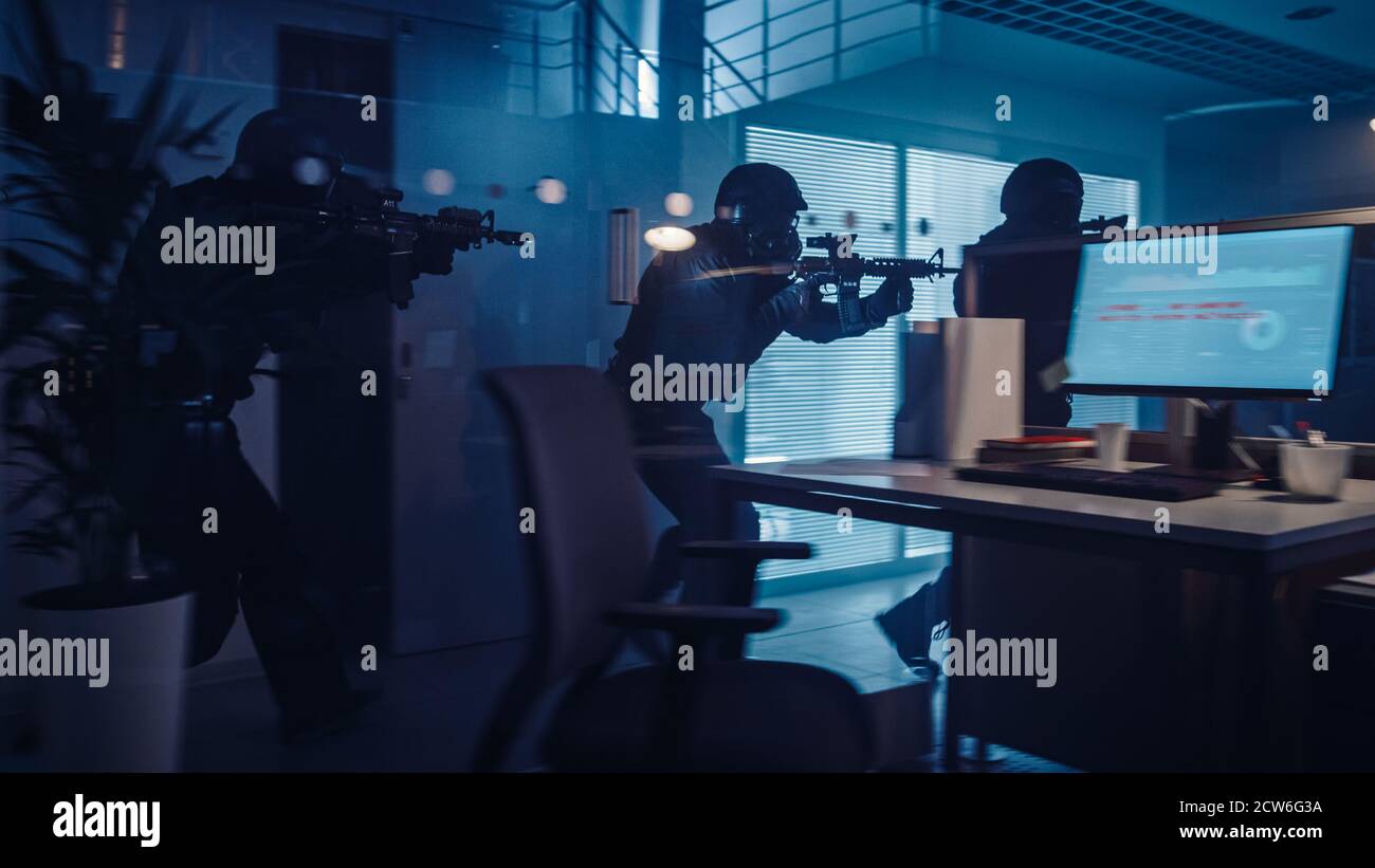 Masked Squad of Armed SWAT Police Officers Move in a Hall of a Dark ...