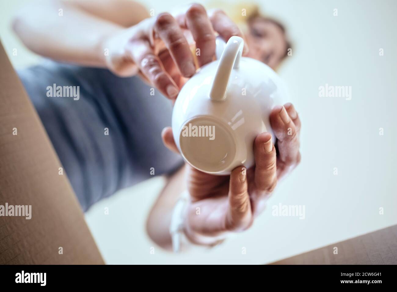 View from below woman unpacking moving boxes Stock Photo - Alamy