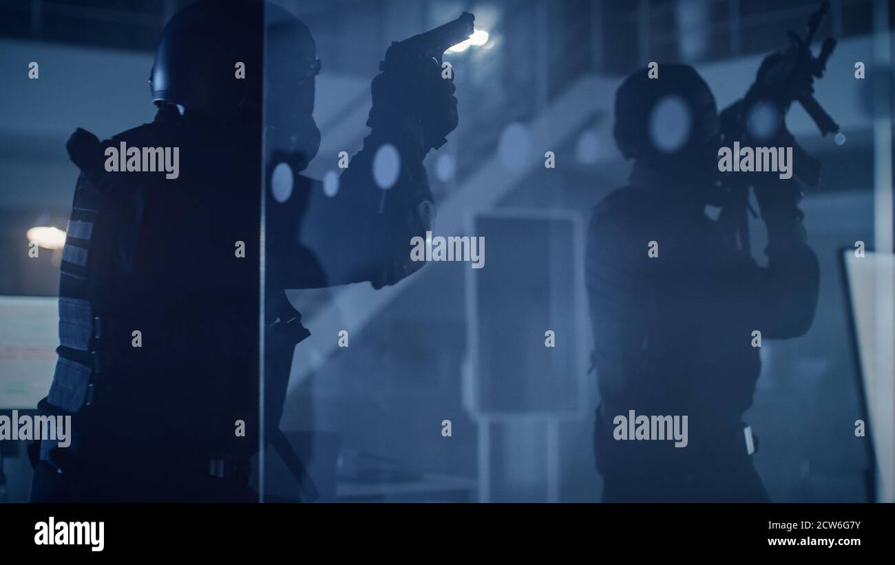 Masked Team of Armed SWAT Police Officers Move in a Hall of a Dark ...