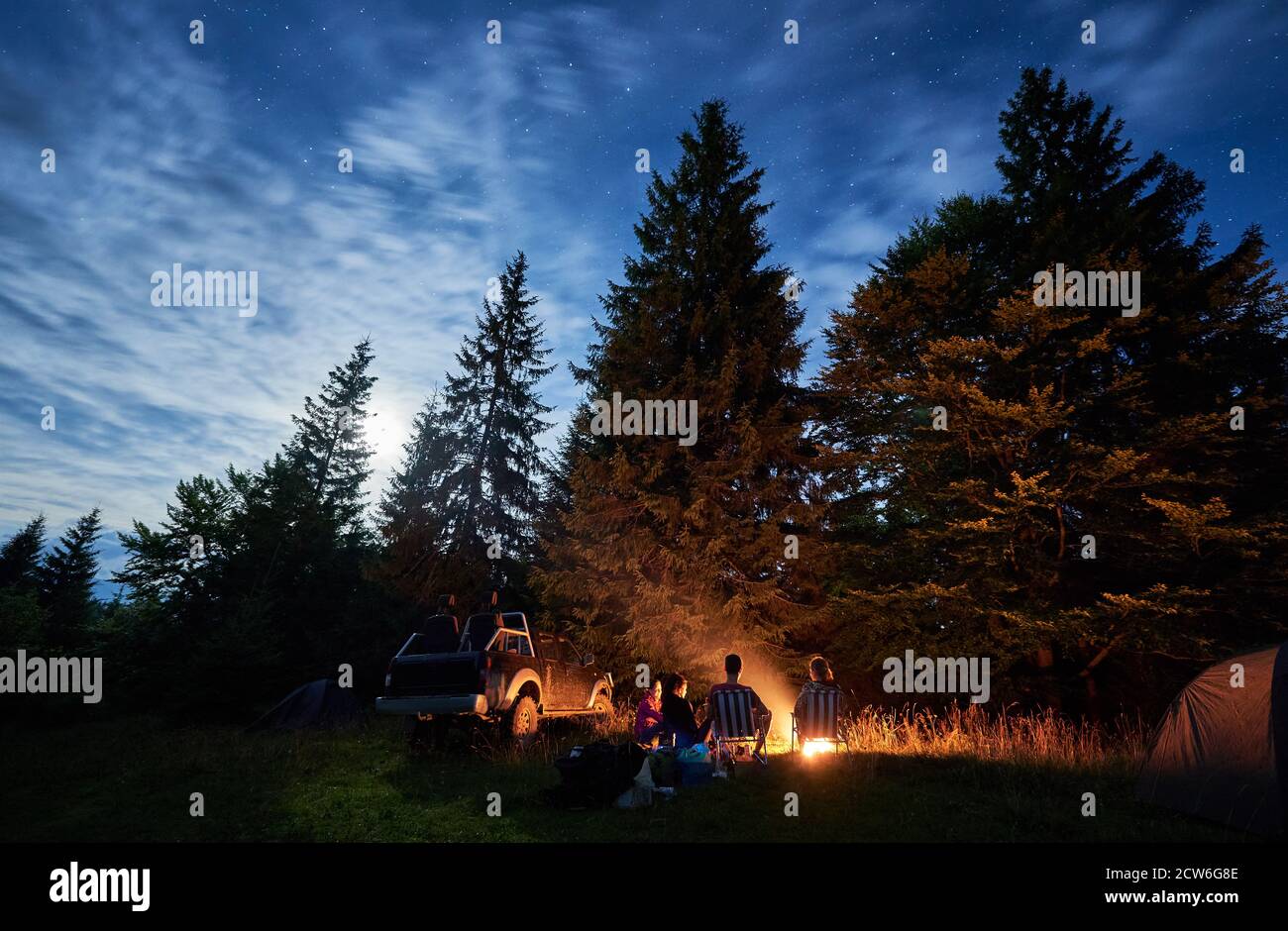 People sitting around campfire night hi-res stock photography and ...