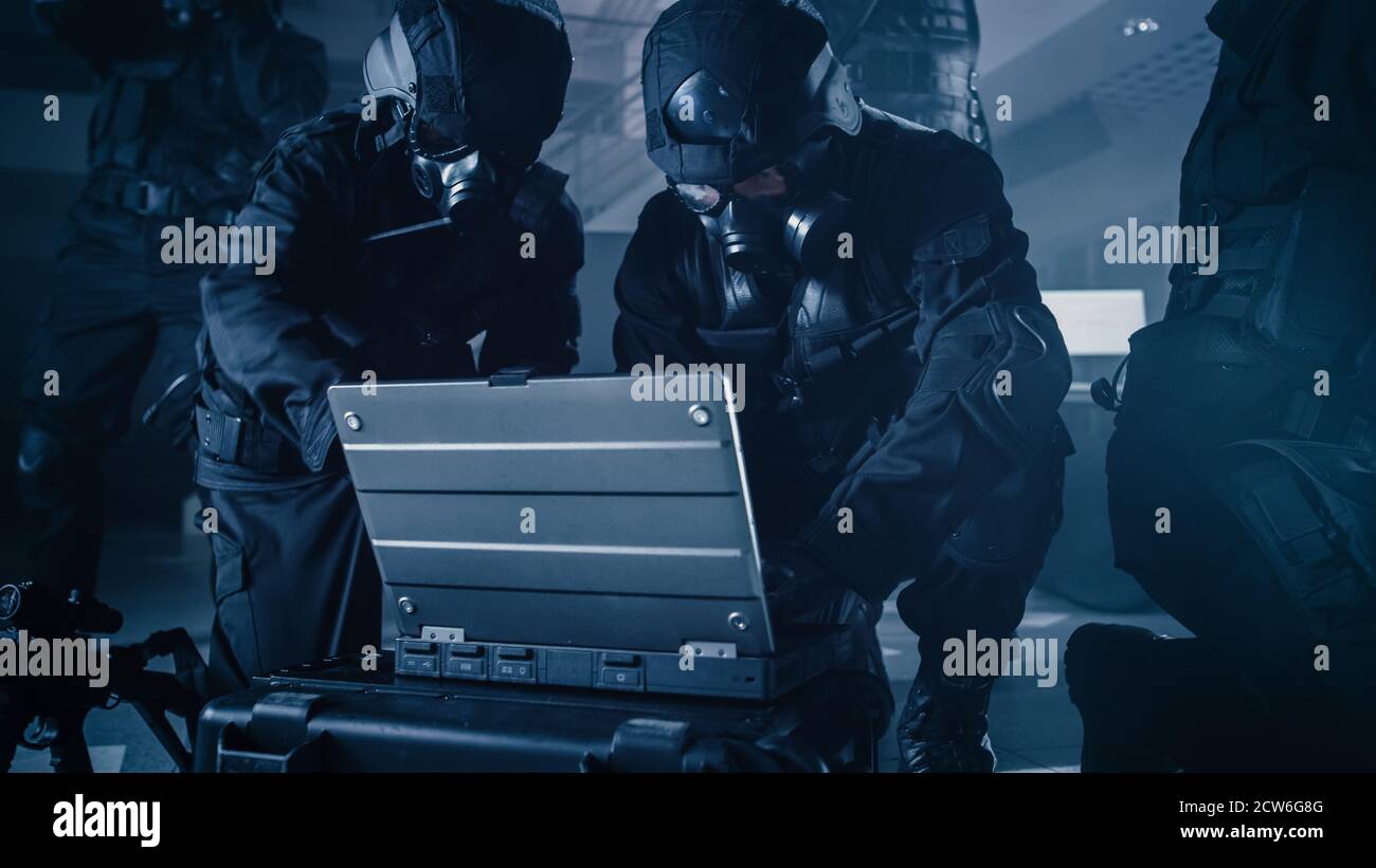 Masked Team of Armed SWAT Police Officers with Rifles are in Dark ...