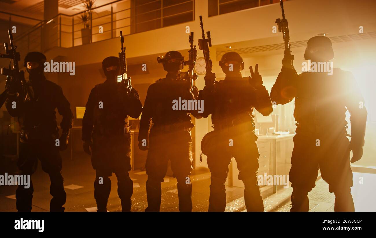 Masked Team of Armed SWAT Police Officers with Rifles are Posing After ...