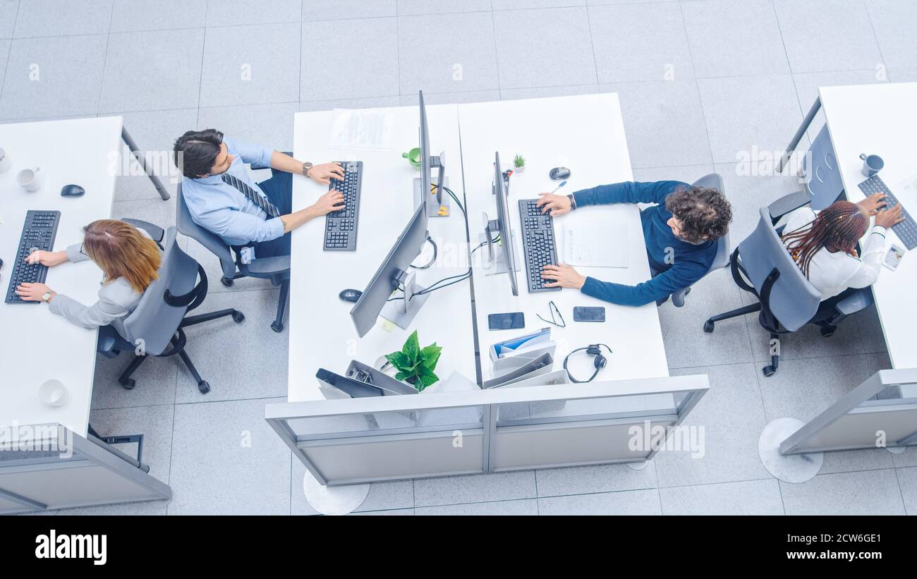 In the Bright Busy Office Rows of Diverse Professionals Working on ...