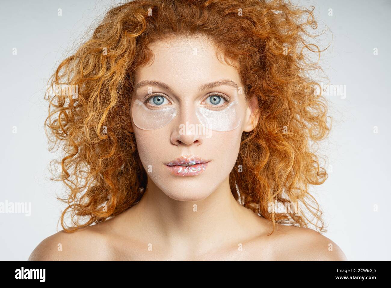 Young red hair woman with patches under eyes Stock Photo - Alamy