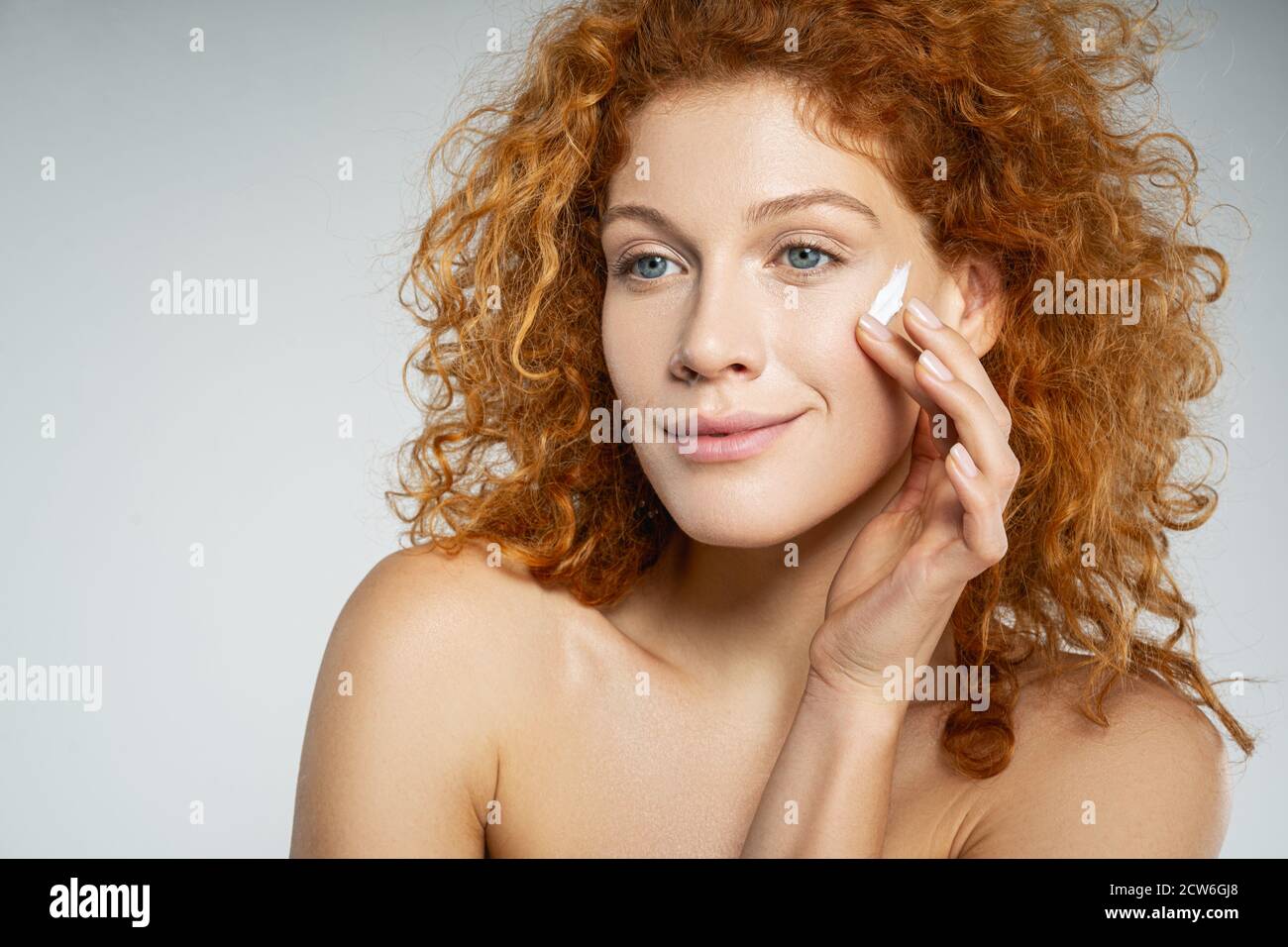 Woman face with revitalizing cream on skin Stock Photo - Alamy