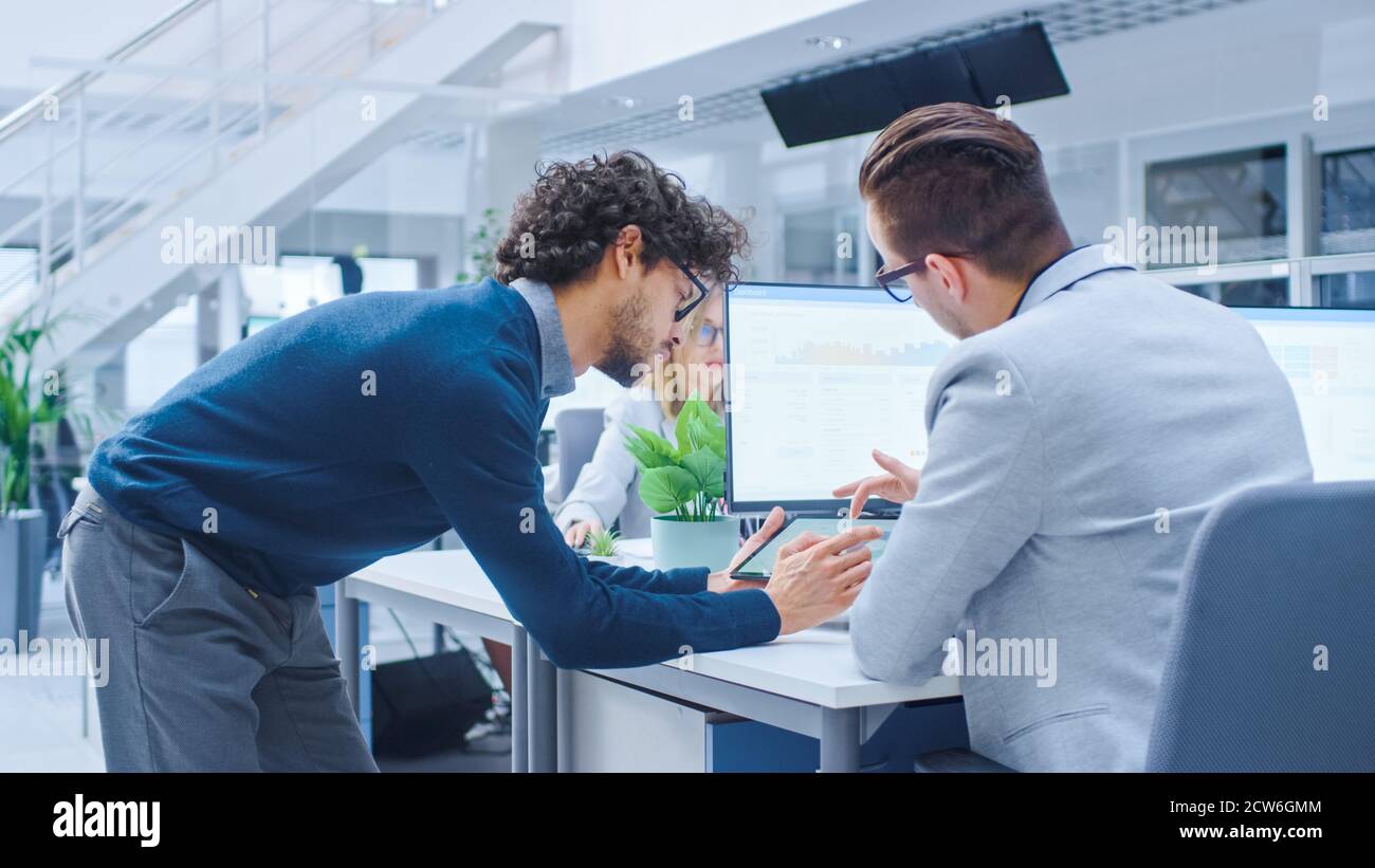 In Bright Modern Office: Office Worker Sitting and Working at His ...
