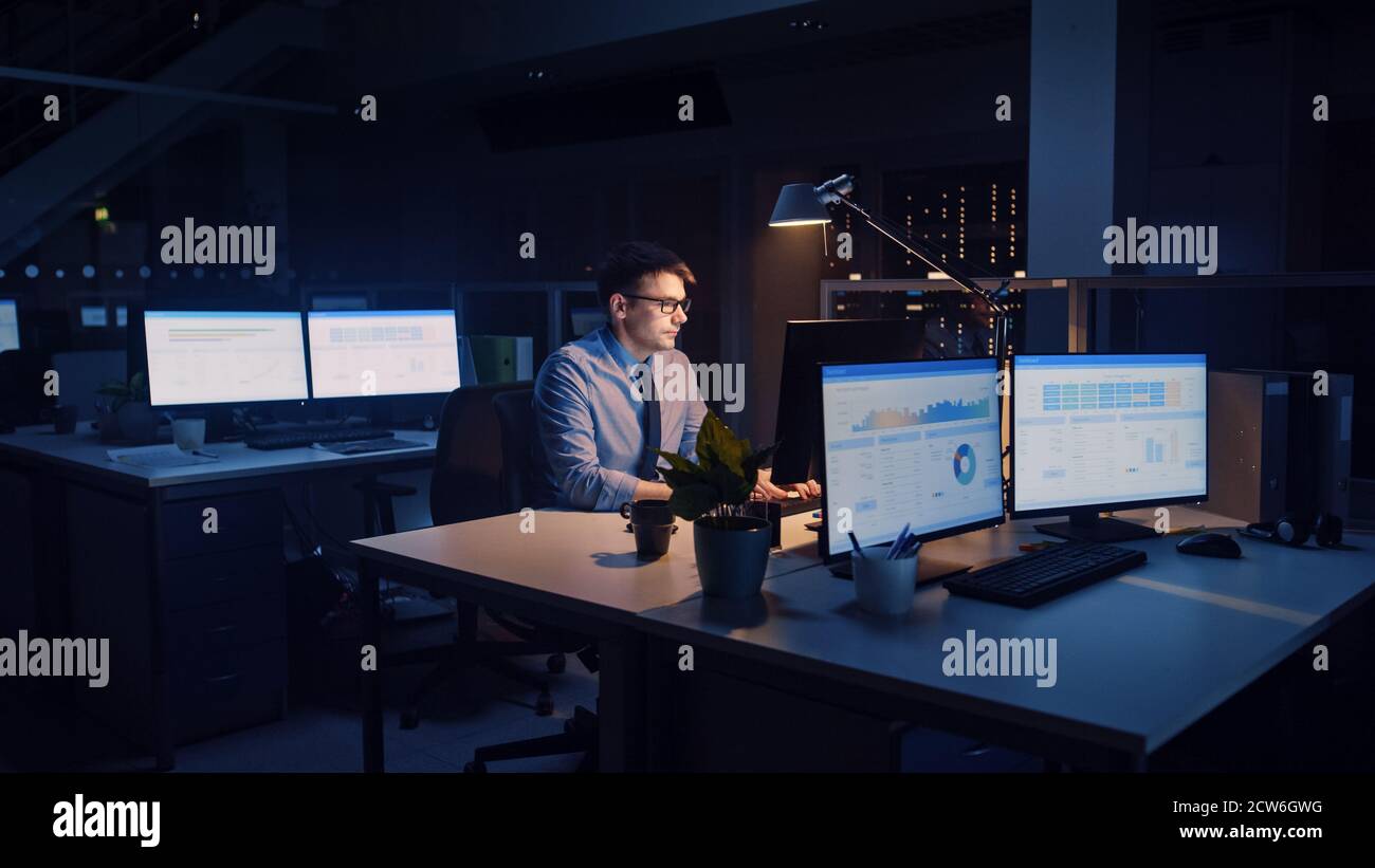 Working Late at Night in the Office: Businessman Uses Desktop Computer ...