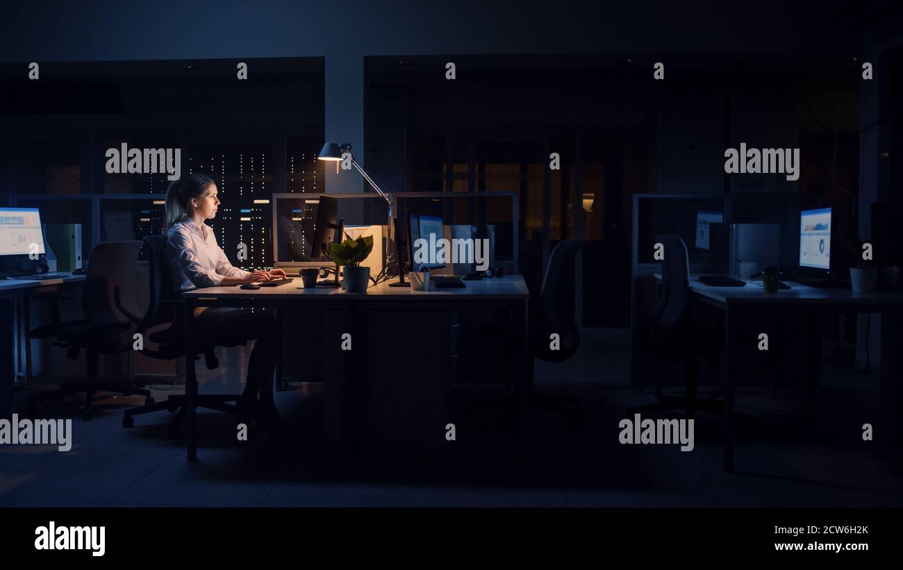 Working Late at Night in the Office: Businesswoman Uses Desktop ...