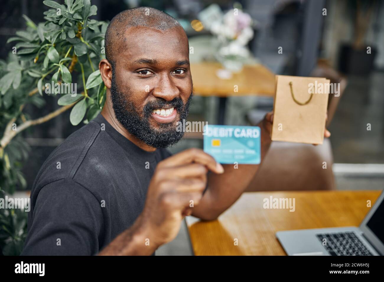 Satisfied client of the bank showing his credit card Stock Photo - Alamy